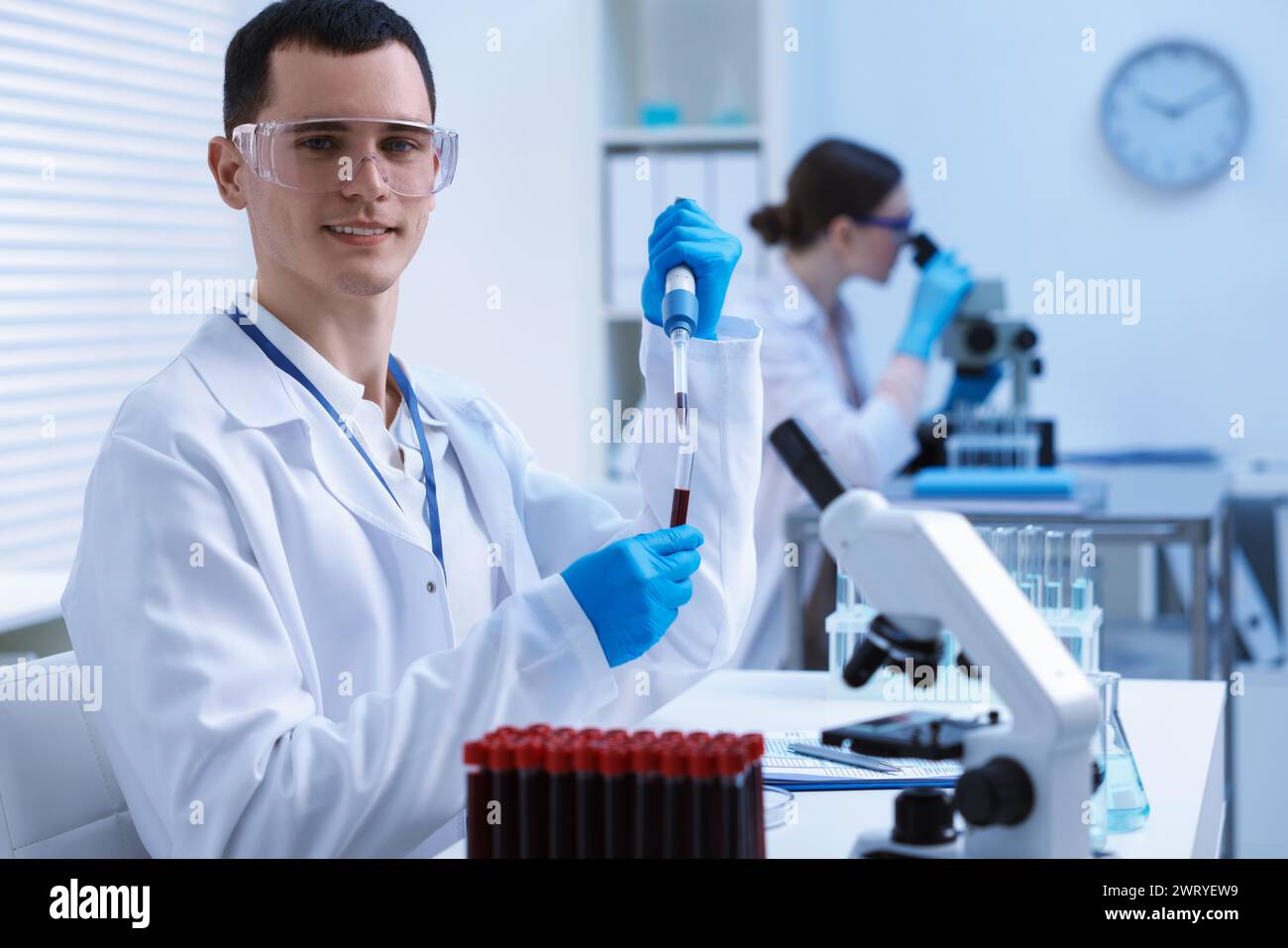 Happy female scientist analyzing test hi-res stock photography and ...