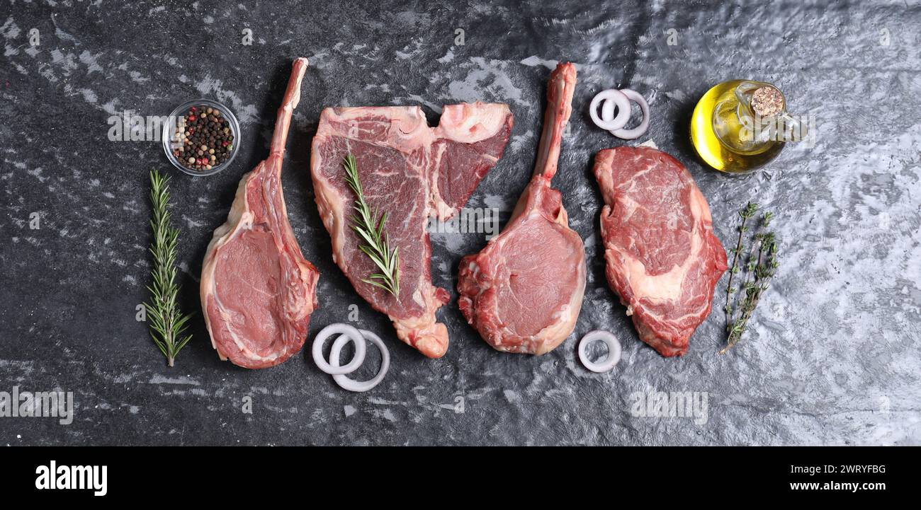 Fresh raw beef cuts and different spices on grey textured table, flat ...