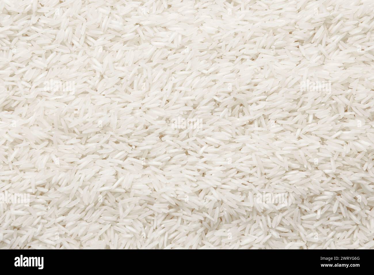 Raw basmati rice as background, top view Stock Photo - Alamy