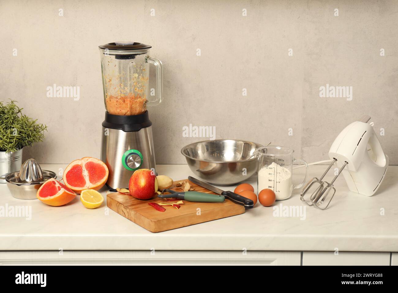 Modern mixer, blender and different ingredients on white marble ...