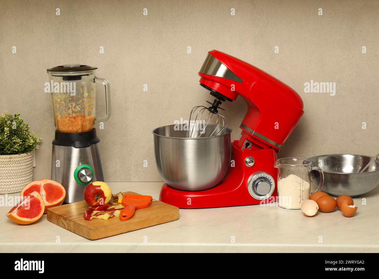 Modern red stand mixer, blender and different ingredients on white ...