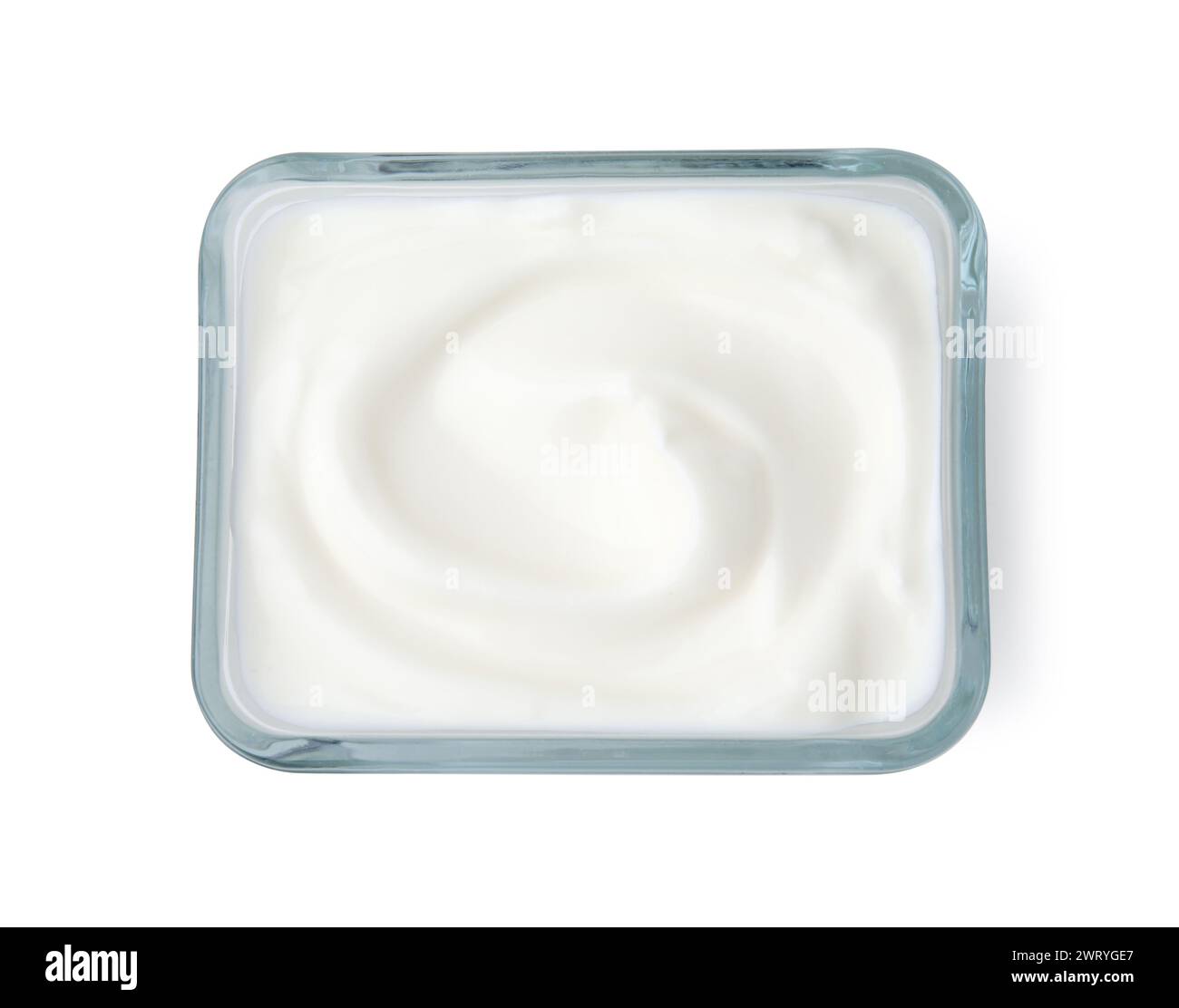 Delicious natural yogurt in glass bowl isolated on white, top view ...