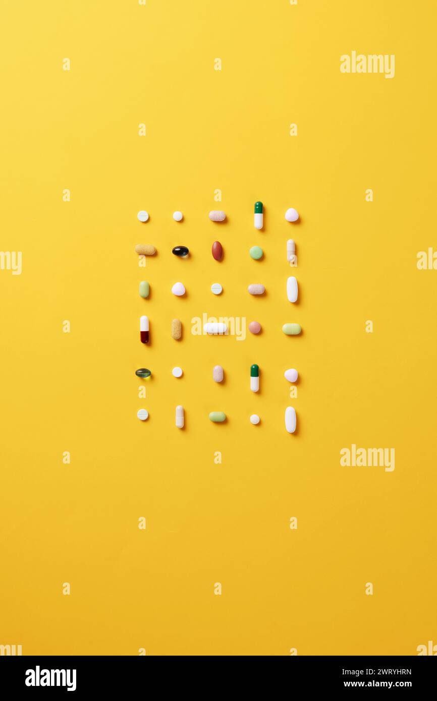Color medicines arranged in a square shape on a yellow background Stock ...