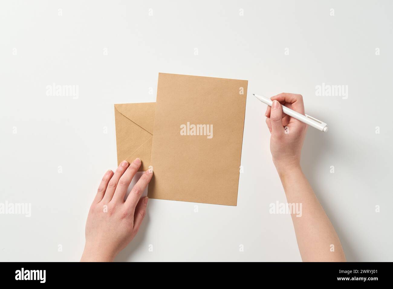 a hand to write on a paper sheet Stock Photo - Alamy