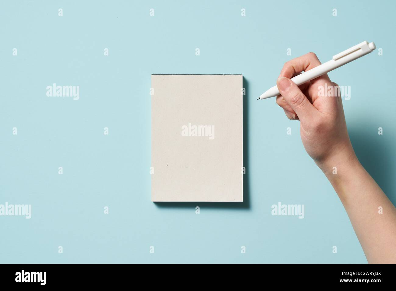 a notepad with a sky blue pastel background Stock Photo - Alamy
