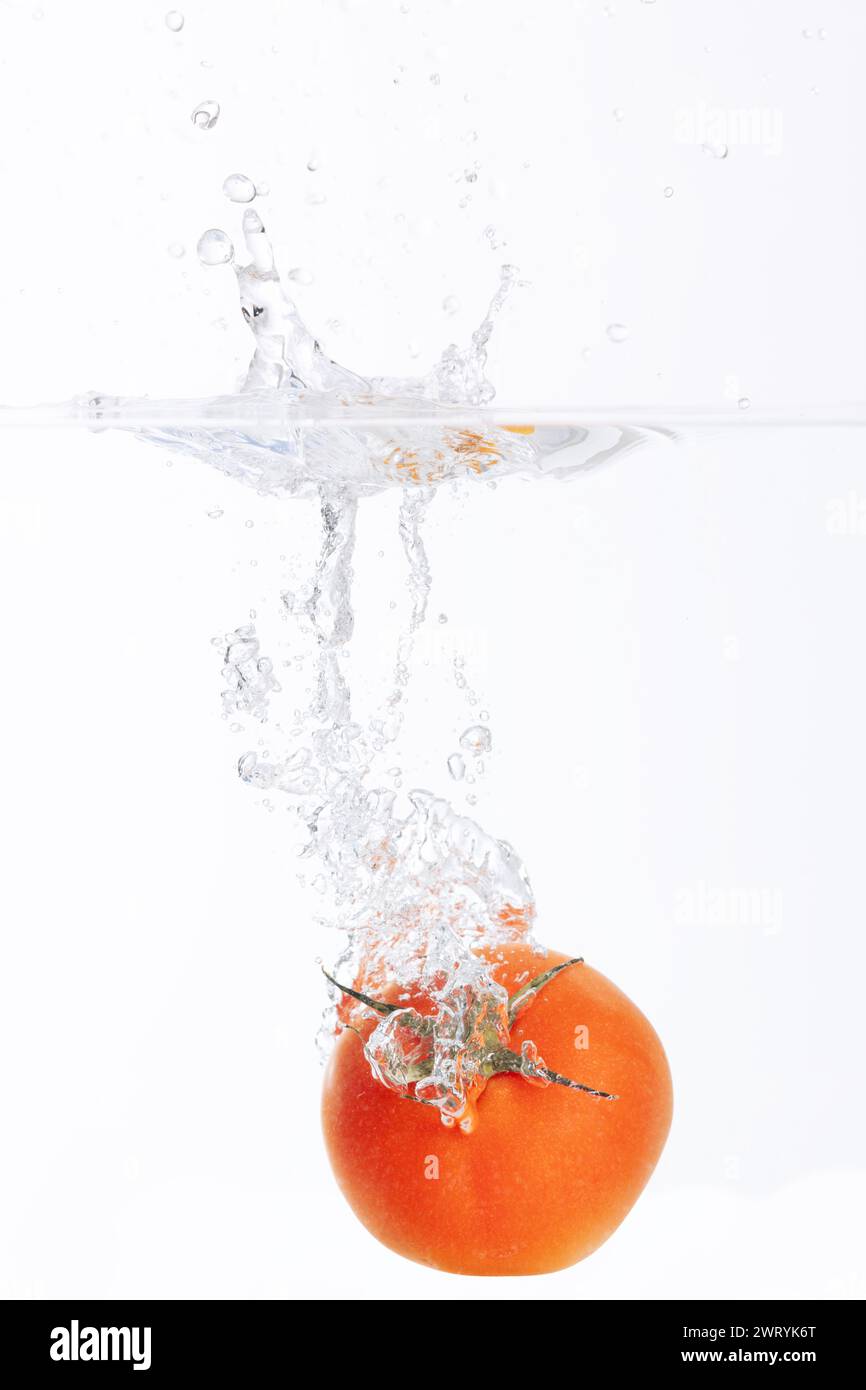 Red Tomatoes Falling Underwater Stock Photo - Alamy