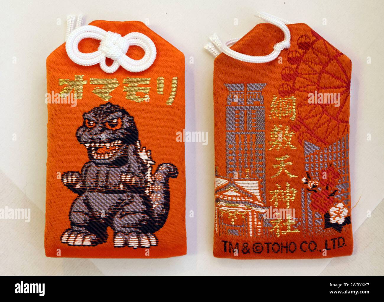 Godzilla Omamori, a good luck charm, are offered at Tsunashiki ...