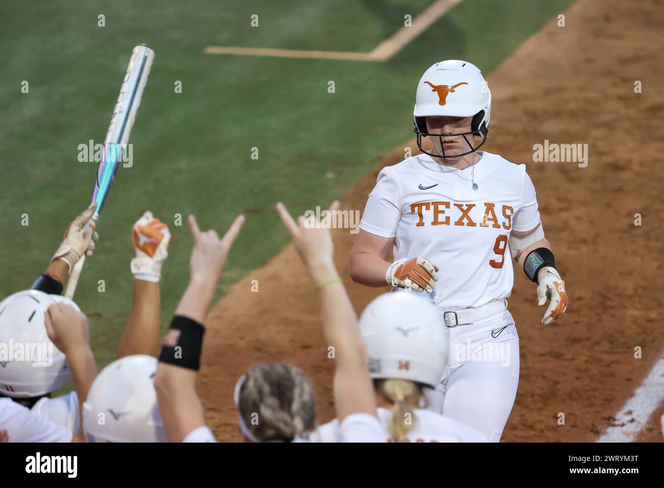 AUSTIN, TX - MARCH 14: Texas infielder Joley Mitchell (9) is welcomed ...