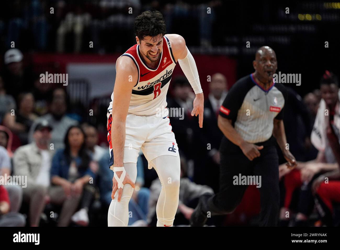 Washington Wizards' Deni Avdija (8) grabs his knee after falling during ...