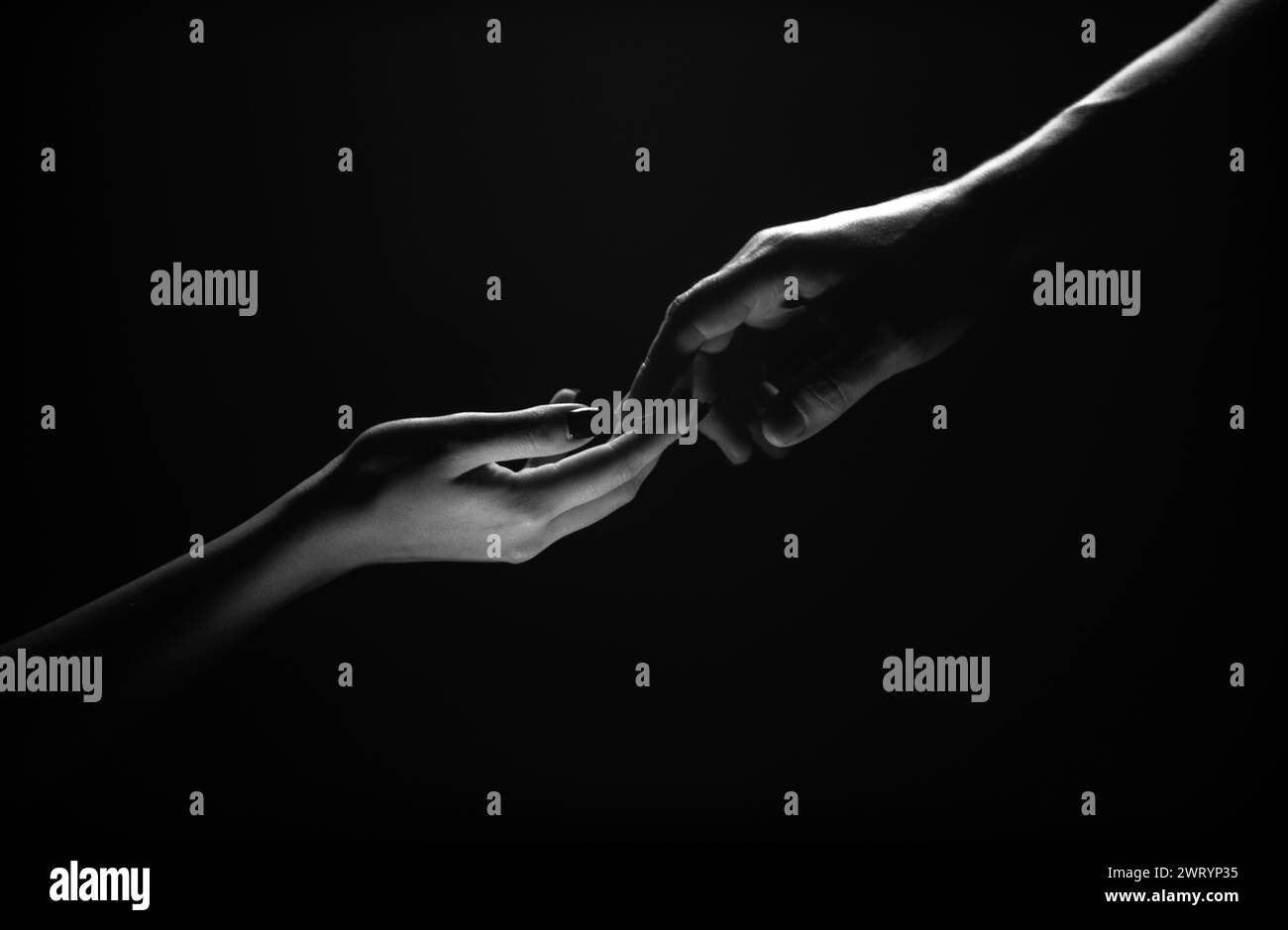 Two hands reaching toward. Tenderness, tendet touch hands in black ...