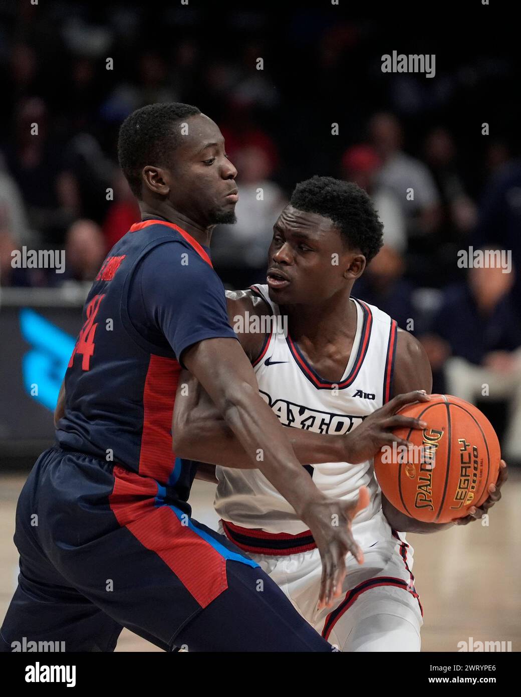 Dayton guard Enoch Cheeks, right, is defended by Duquesne forward ...