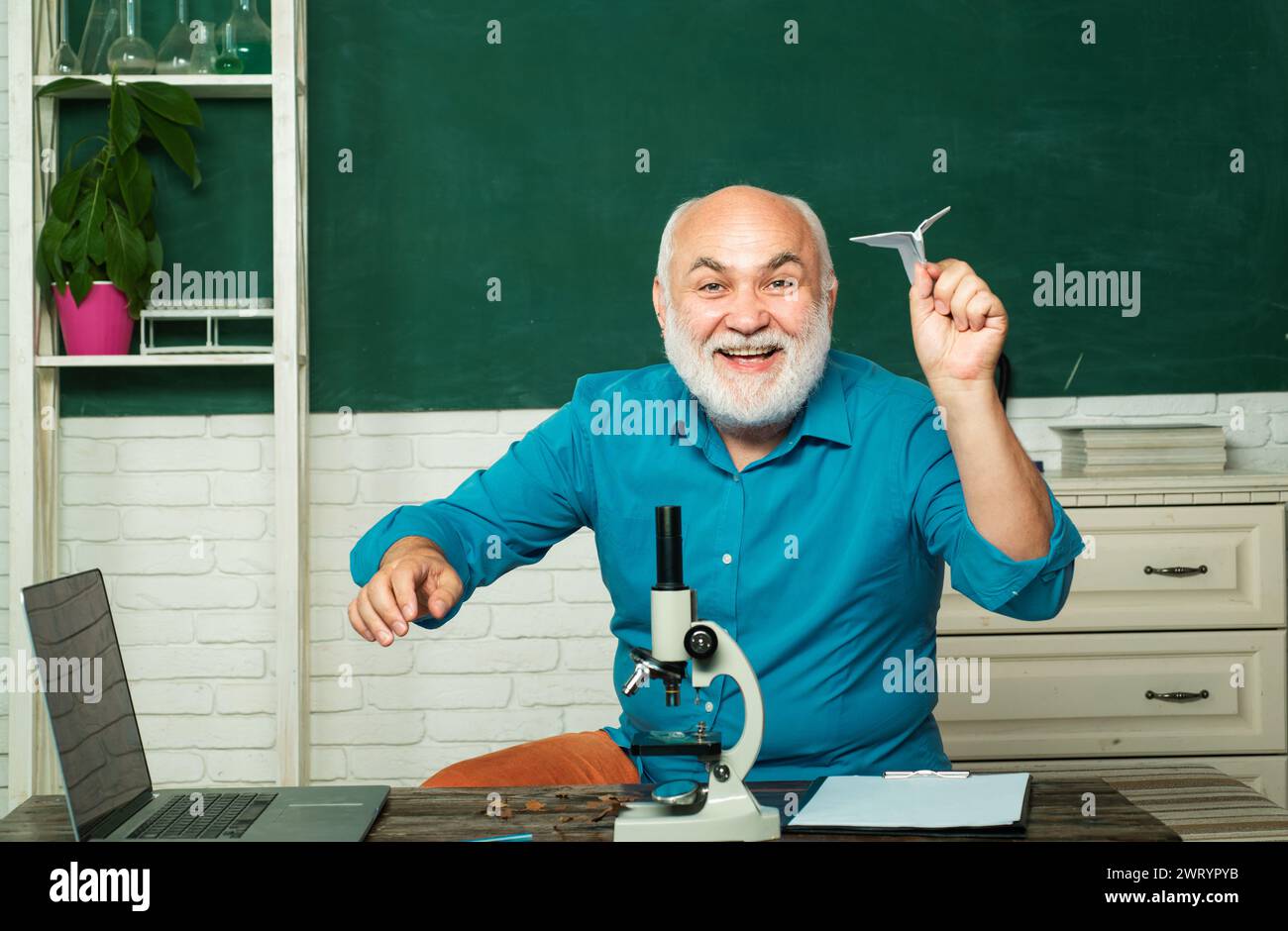 Bearded professor at school lesson at desks in classroom. Bearded ...