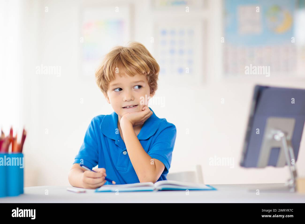 Child doing homework on computer. Online class. Homeschooling and ...