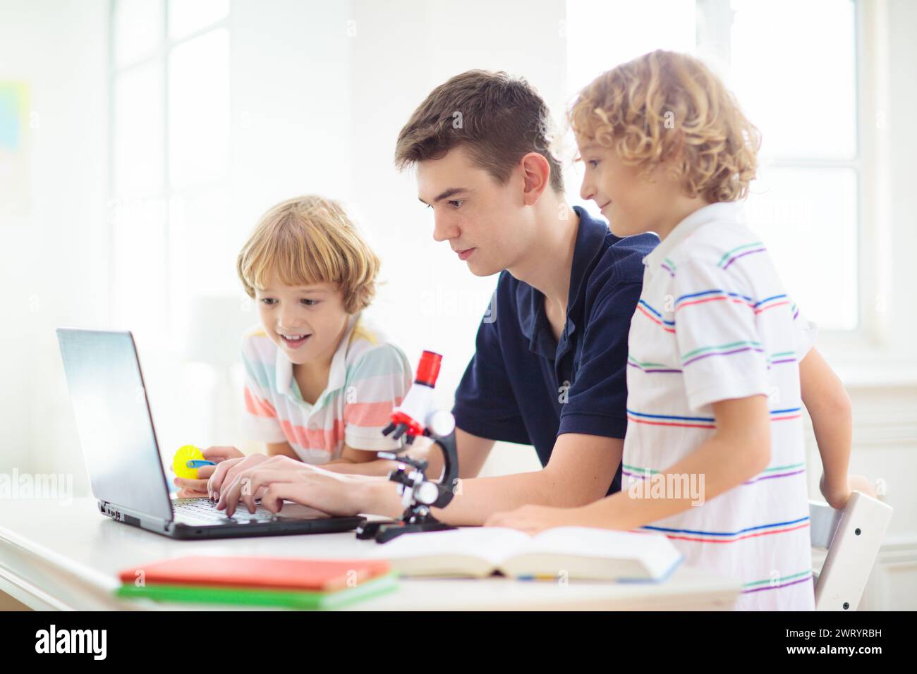 School kids with microscope. Science class. Children making biology or ...