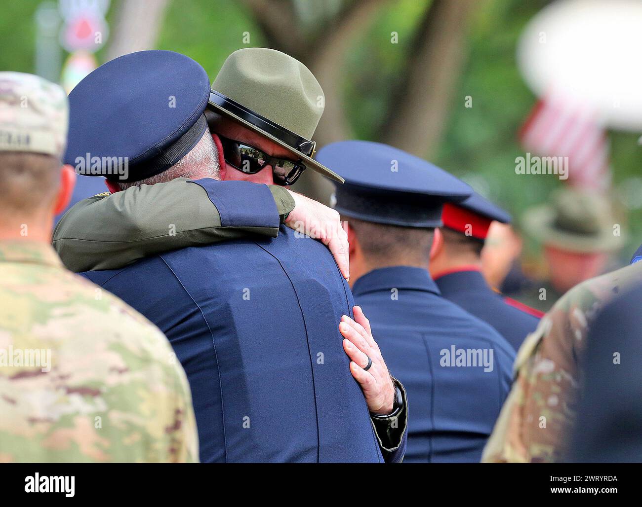 A Border Patrol agent hugs a police officer before the body of Chris ...