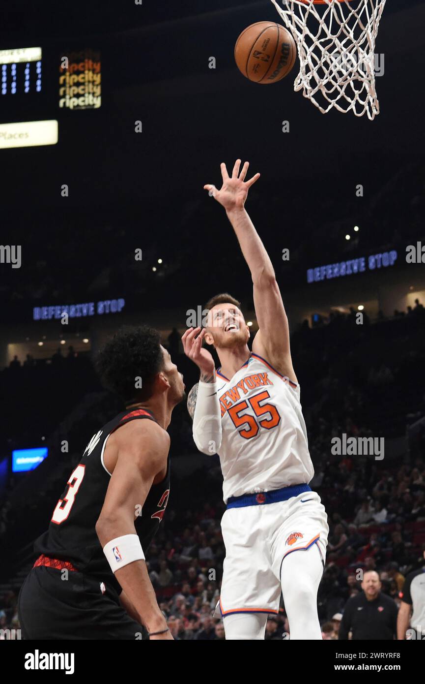 New York Knicks center Isaiah Hartenstein, right, shoots over Portland ...