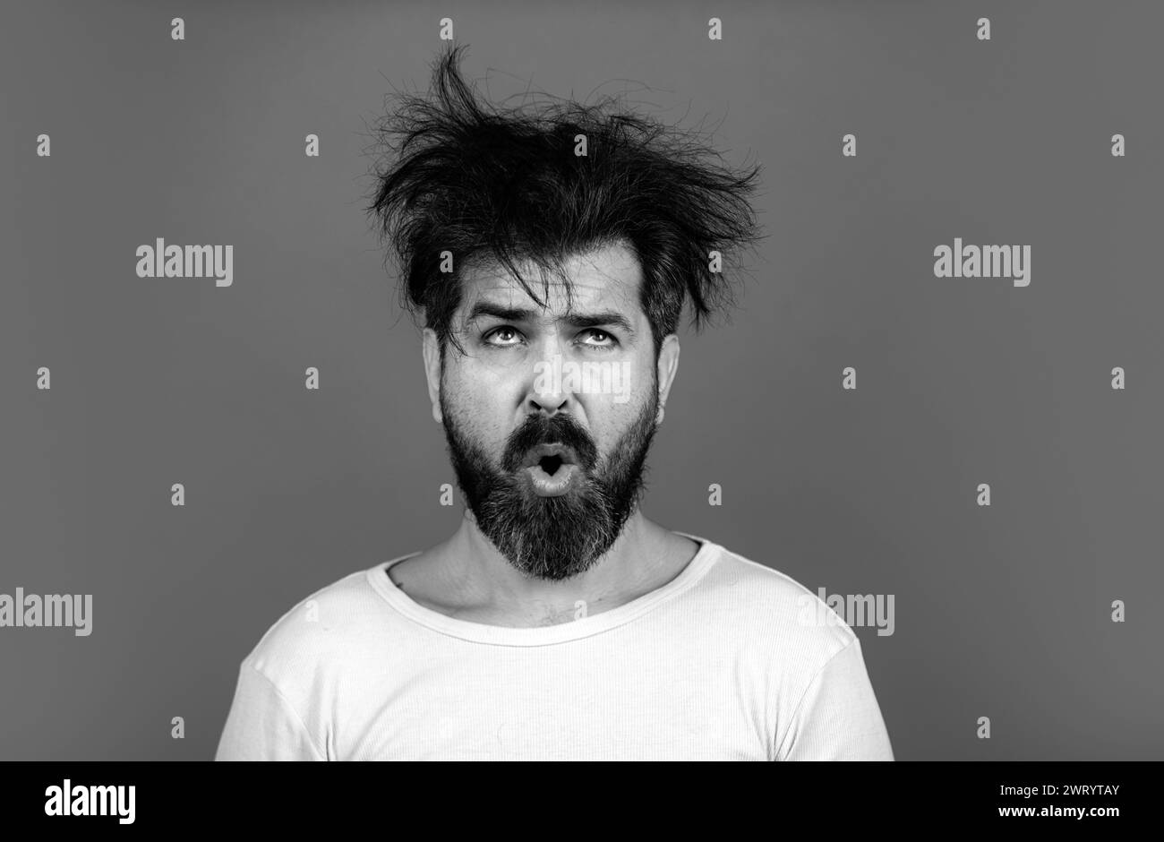 Funny and crazy. Bearded man with messy hair. Barbershop concept. Long ...