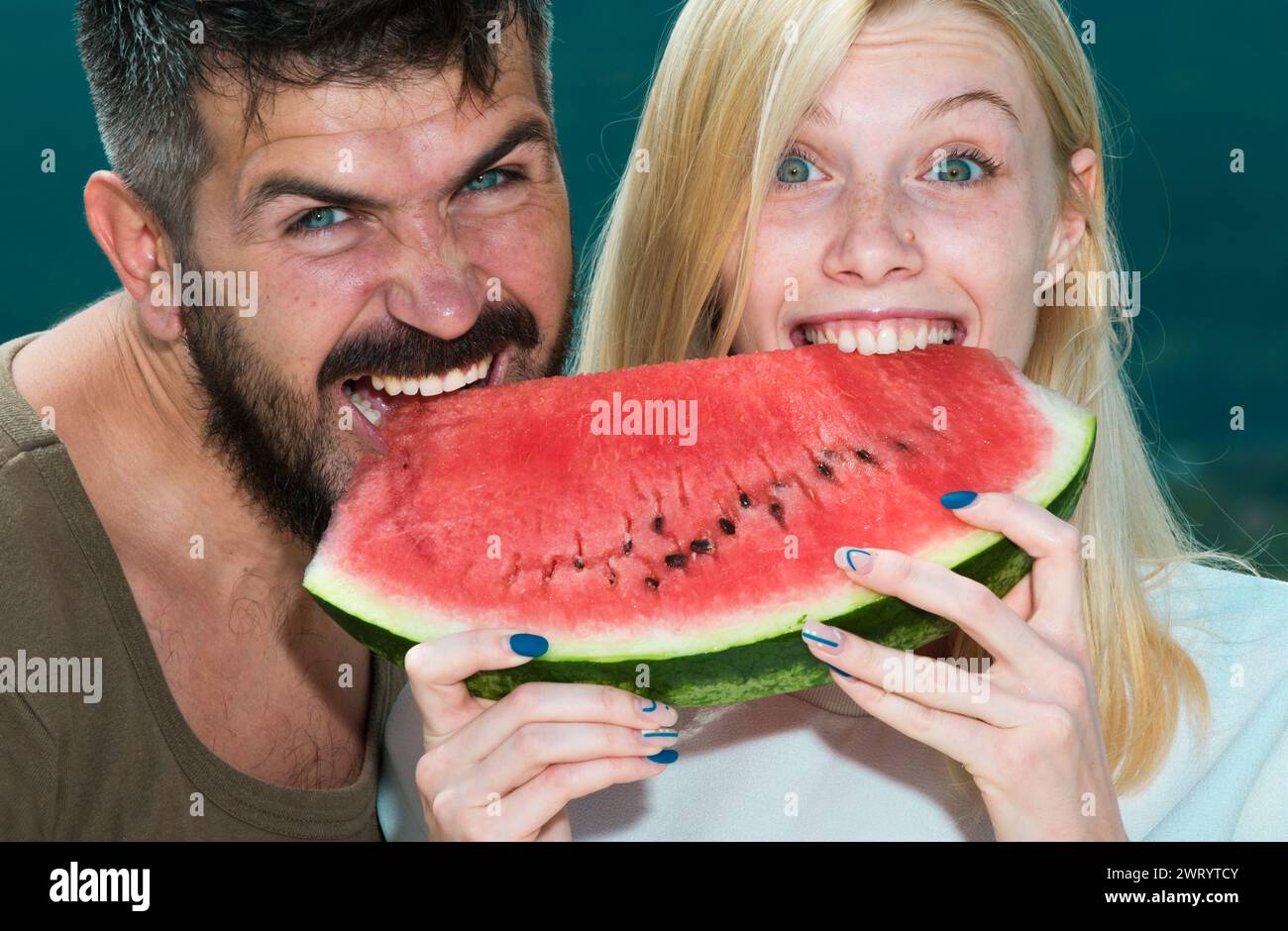 Happy carefree couple eat watermelon. Vitamins and healthy concept ...