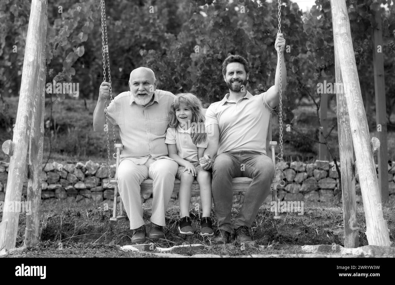 Men generation family playing on swing together Three different ...