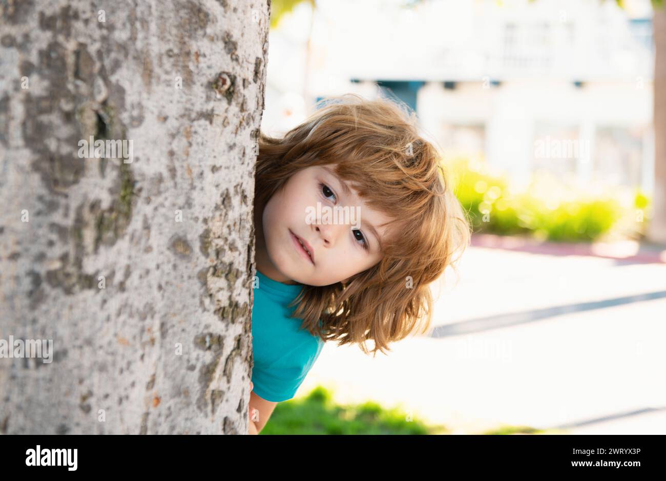 Hide and seek. Peekaboo. Little kid hide by tree. Kids vacation Stock ...