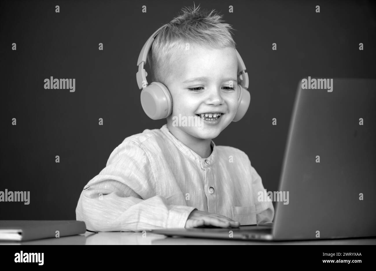 Cute little child using laptop computer, kid boy studying through ...