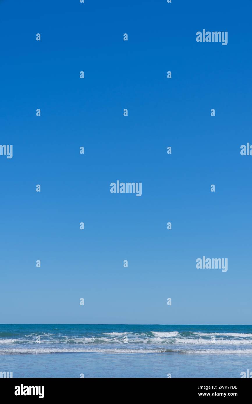 Opunake surf beach with west coast black sand, blue sky and water Stock ...