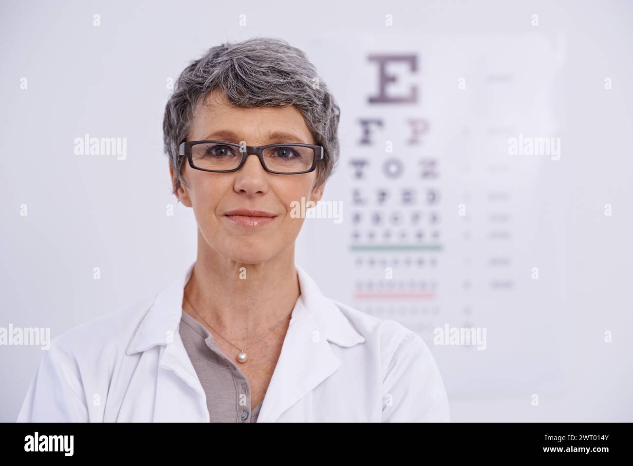 Portrait, senior woman and optometrist for eye care, letter chart for ...