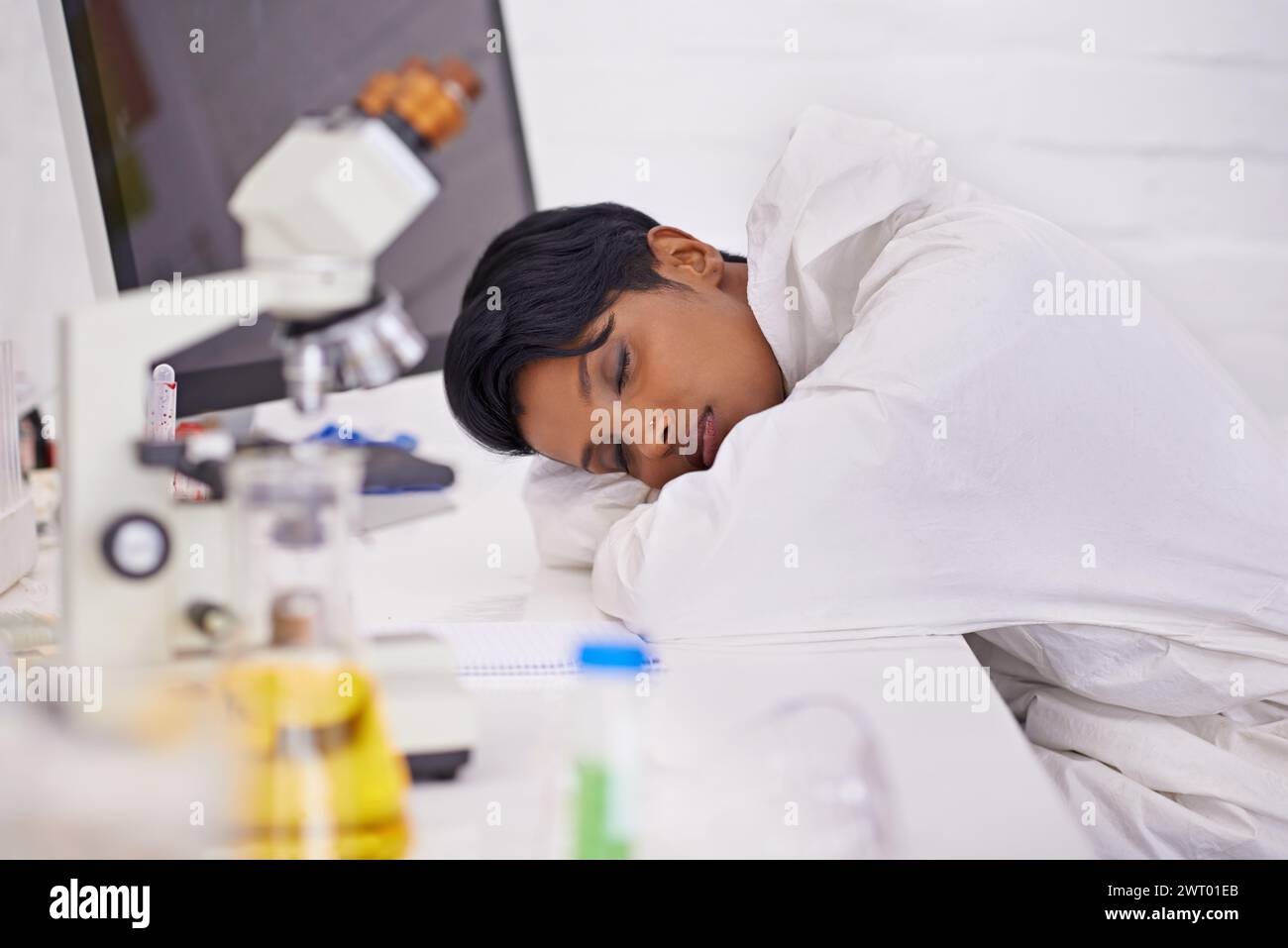 Sleeping, tired and woman scientist in laboratory working overtime on ...