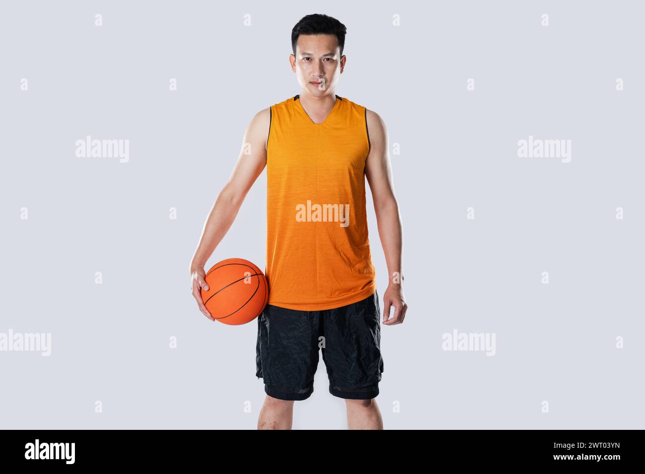 Male basketball player wearing sportswear holding basketball on white ...