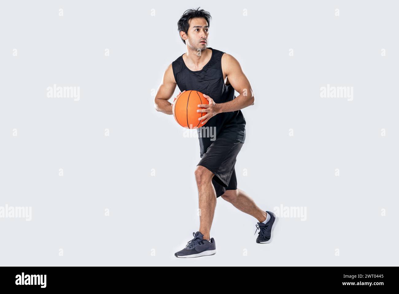 Male basketball player wearing sportswear holding basketball on white ...