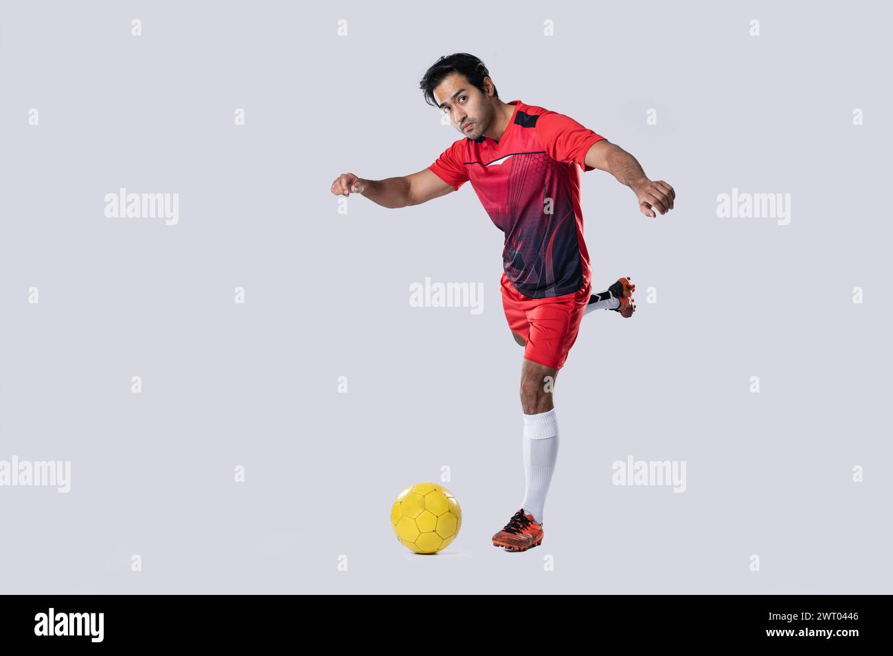 professional football player in red training uniform pose on a white ...