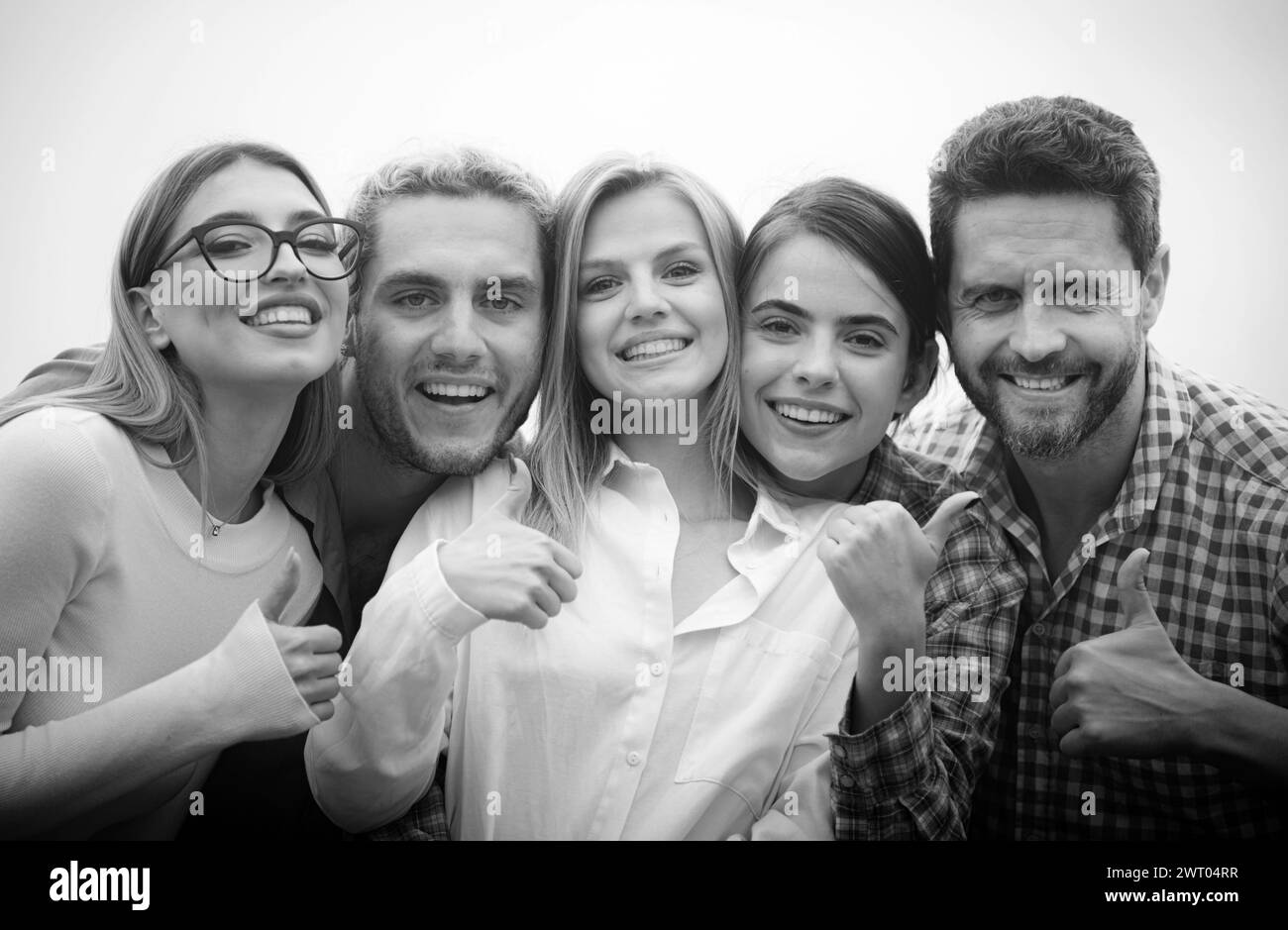 Smiling group of friends laughing with thumb up. Happy company students ...