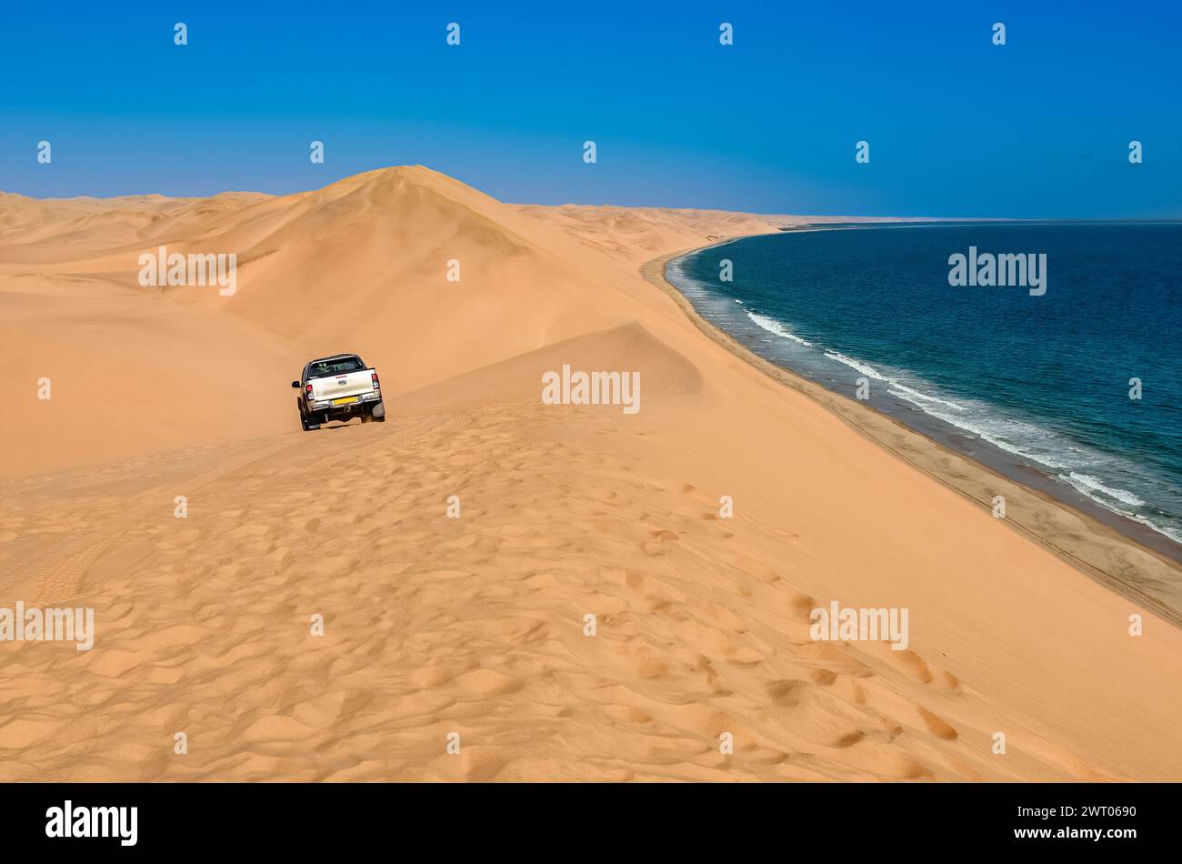 Safari trip by car through sand dunes on ocean shore of Sandwich ...