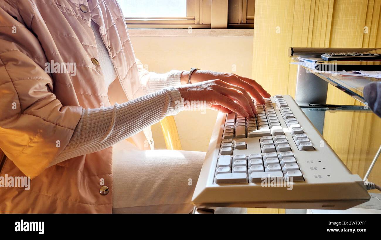 Career woman who works at a computer in the office and types on the ...