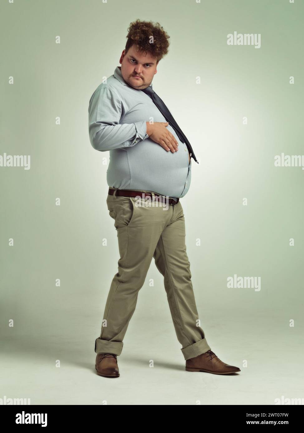 Business man, portrait and plus size with stomach gesture and silly in ...