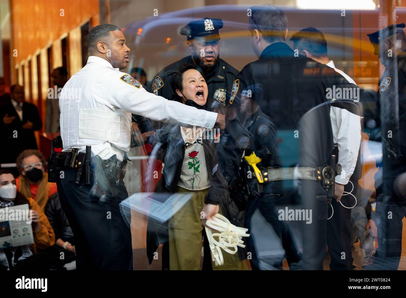New York, United States. 14th Mar, 2024. Police escort handcuffed pro ...