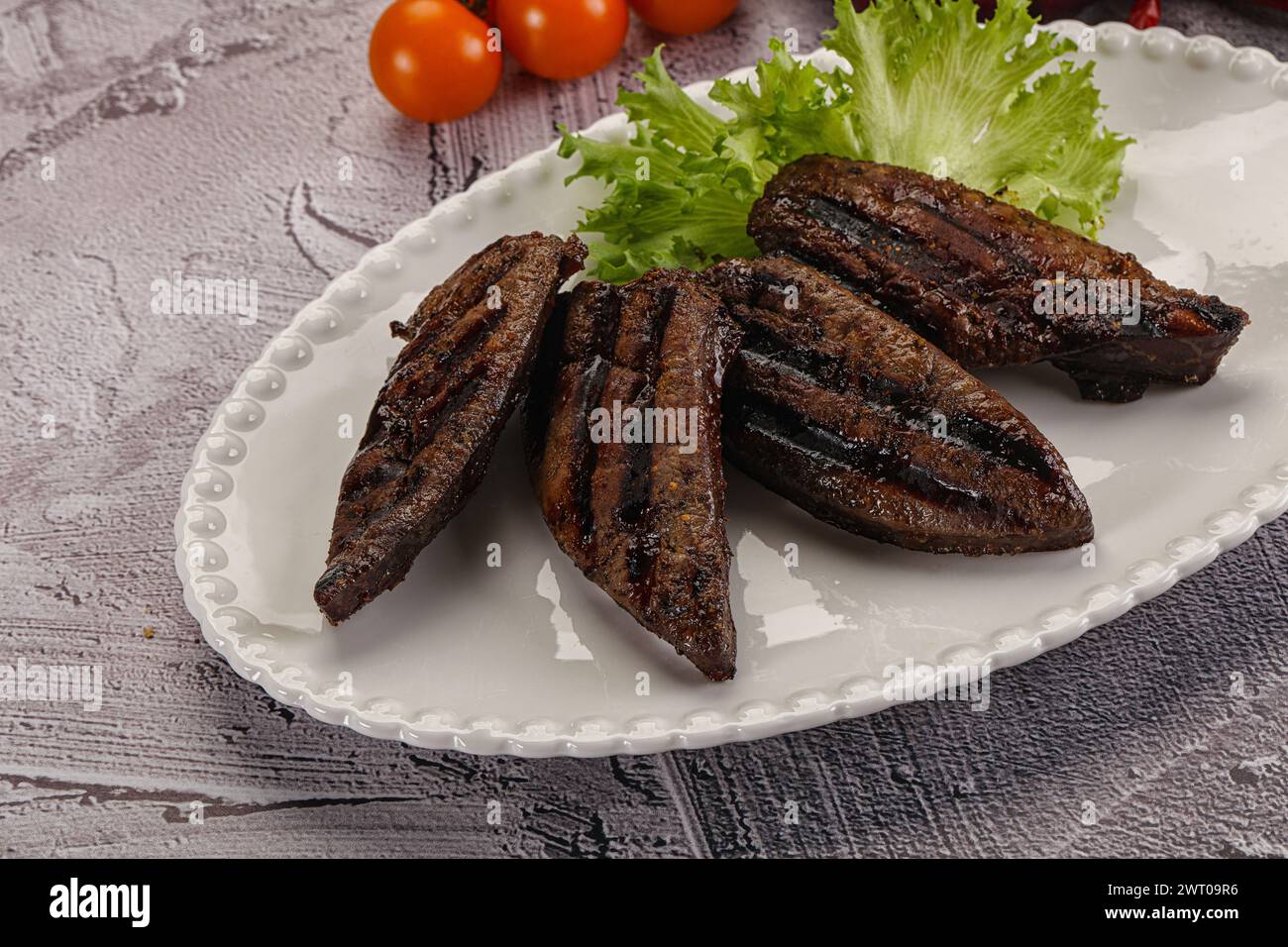 Grilled diet beef liver steak in the plate Stock Photo - Alamy