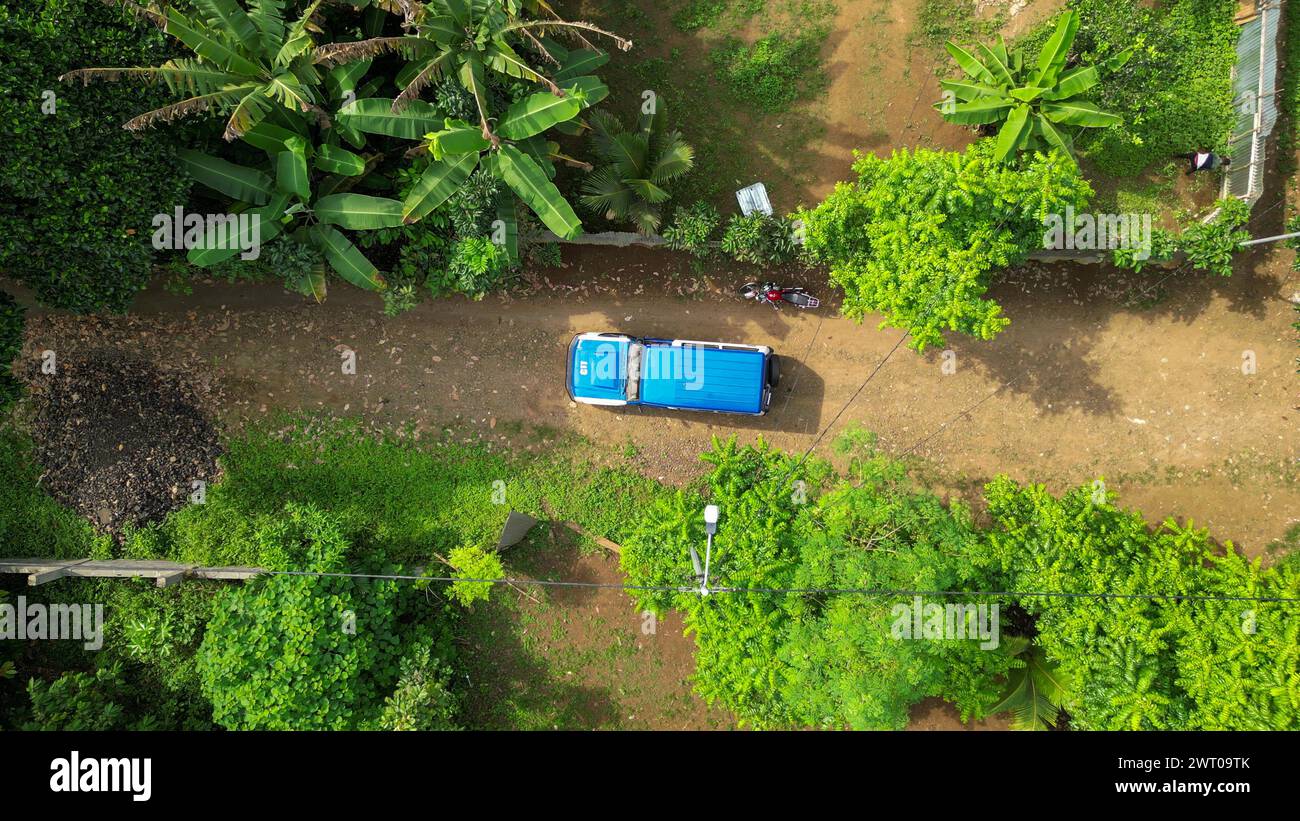 An Aerial view of a police blue car parked beside a forest in Africa ...