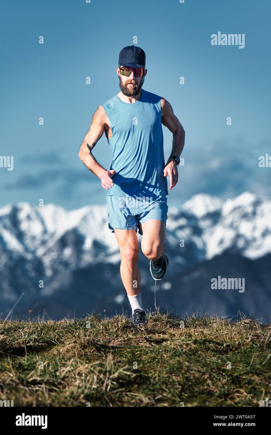 High mountain training a man running alone Stock Photo - Alamy