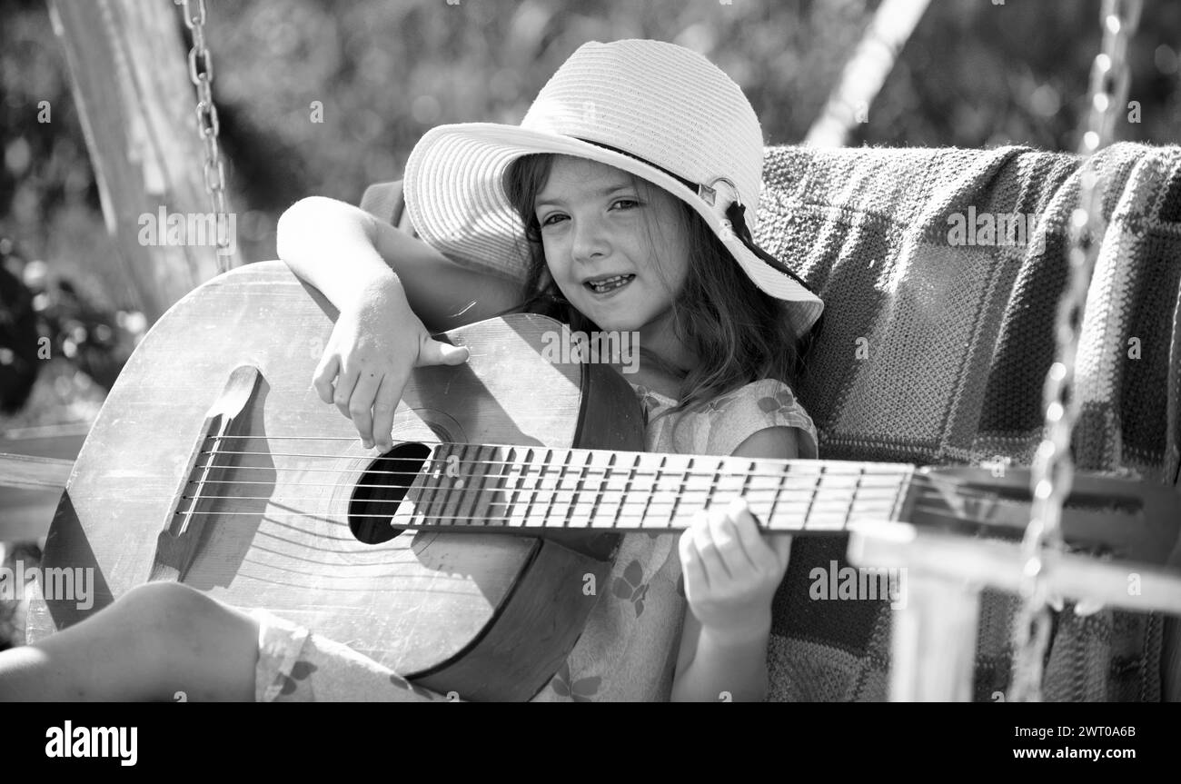 Kids music and songs. Child musician playing the guitar like a rockstar ...