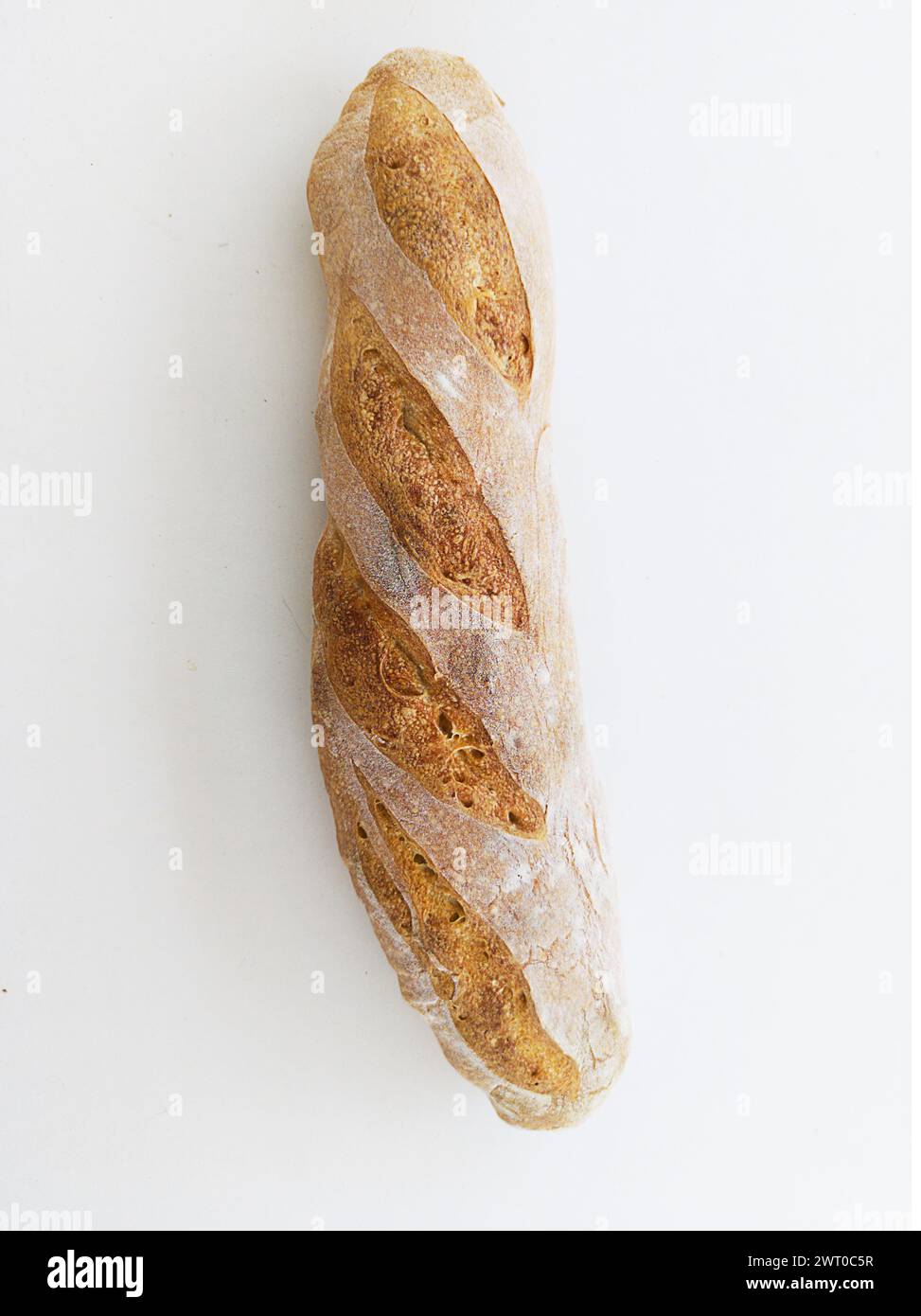loaf of bread handmade in a wood oven. Vertical shot with natural light ...
