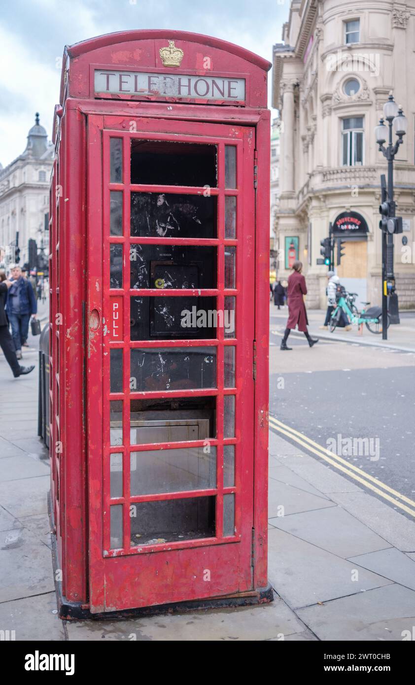Traditional British red telephone box, no longer in use, on city ...