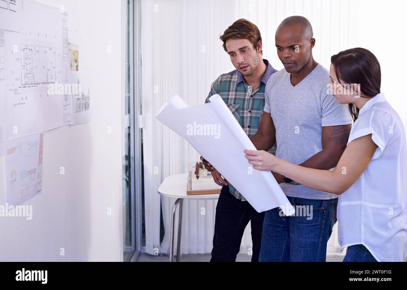 Architecture, people and teamwork with blueprint in office for building ...