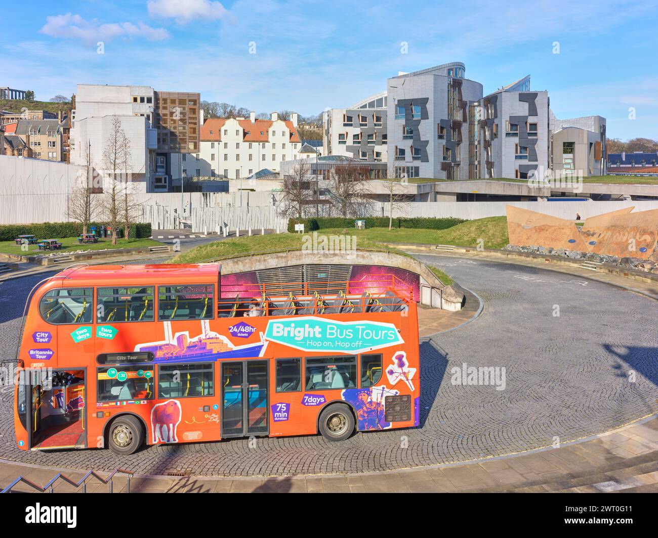Open top double decker tour bus in front of the scottish parliament ...