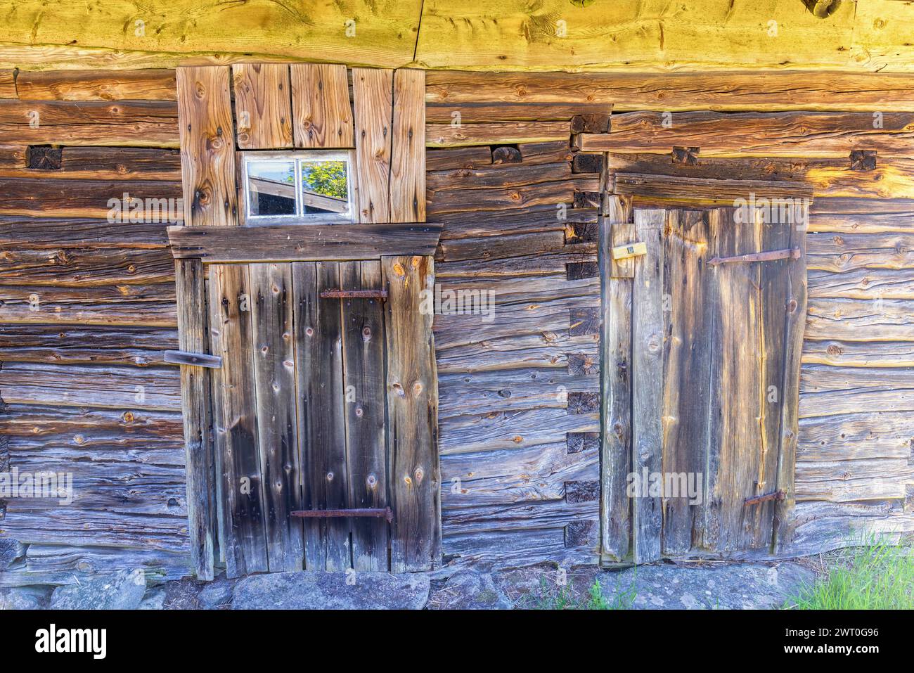 Old weathered log barn with doors and windows on a farm Stock Photo - Alamy