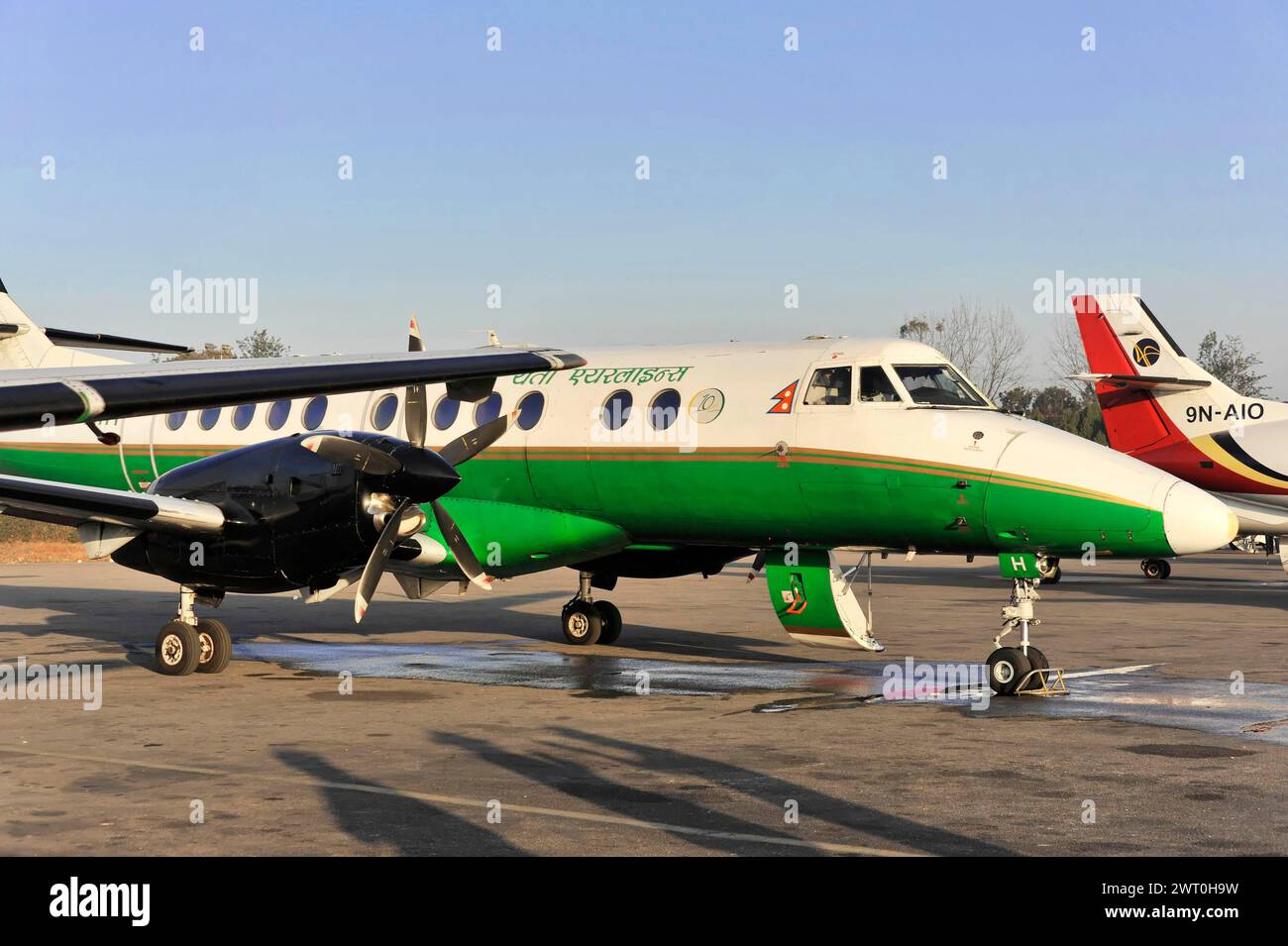 Green propeller plane parked on an airport runway, impressions of the ...
