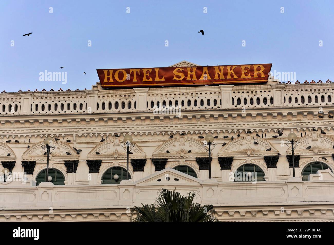 Close-up of the nameplate of a hotel in front of a clear sky with ...