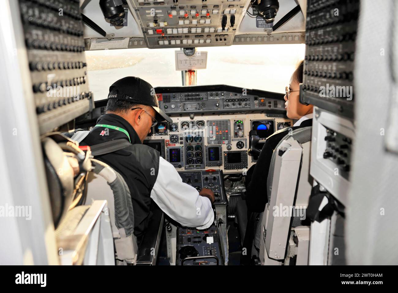 Two pilots in the cockpit of an aeroplane in front of the instrument panel, impressions of the ...
