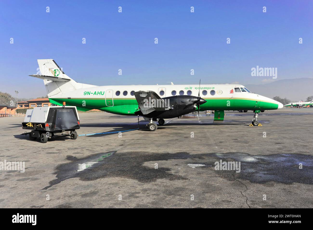 Ground crew working on a parked aircraft on the tarmac, impressions of ...