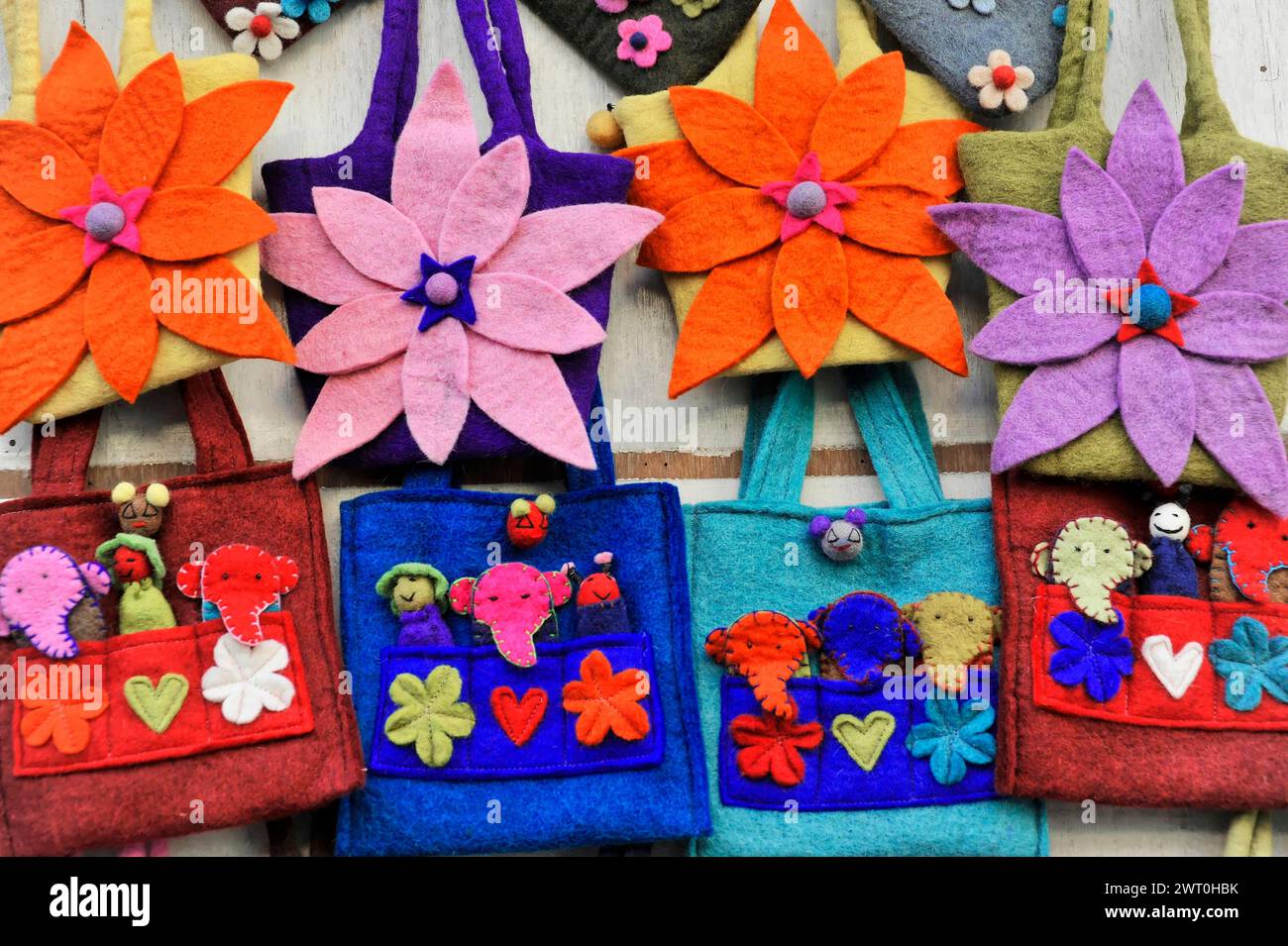 Colourful felt bags with flower patterns and small toys, impressions of ...